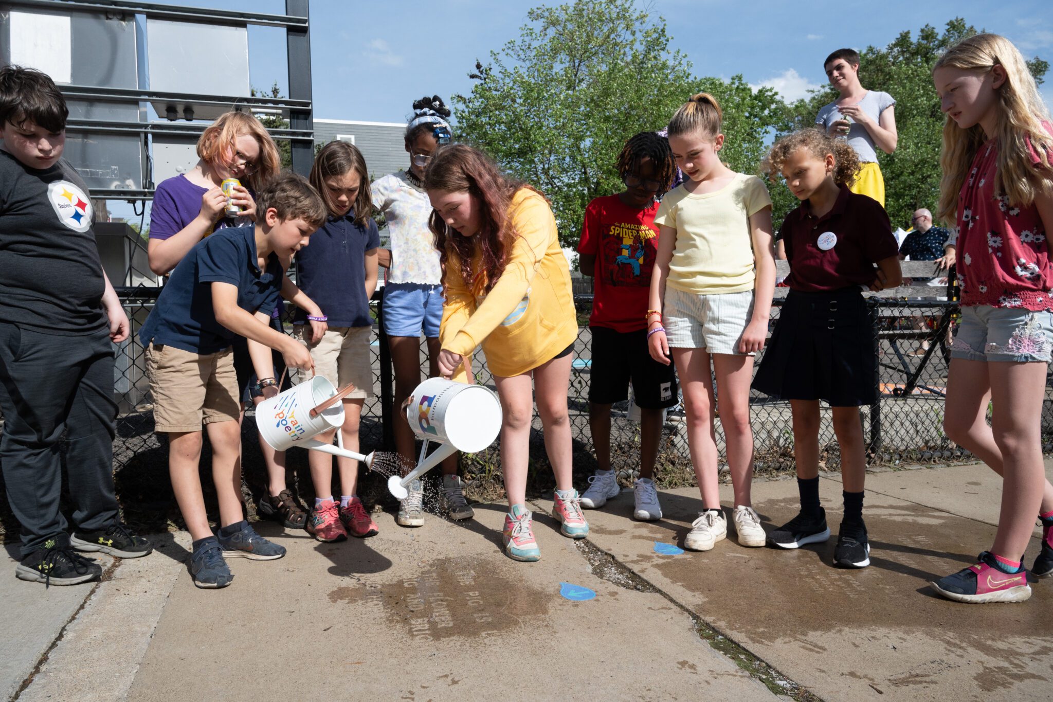 Students celebrate their words coming to life at Rain Poetry reveal in Pittsburgh's Garfield ...